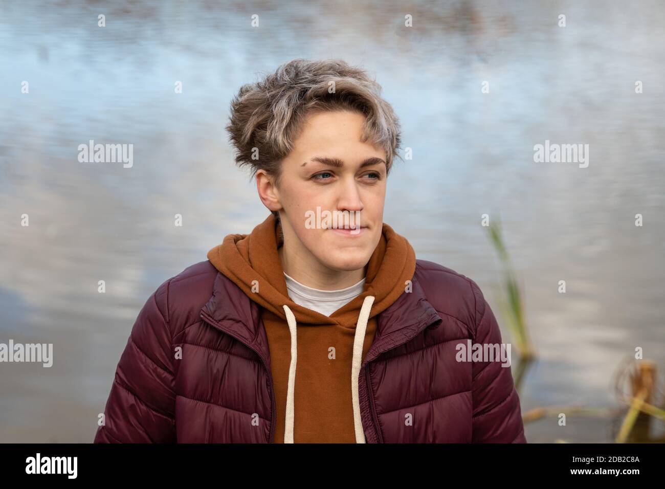 New femininity - gender neutral style. Young woman with stylish short ...