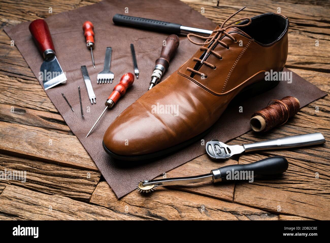 Shoemaker Tools And Finished Shoe On Desk Stock Photo - Alamy
