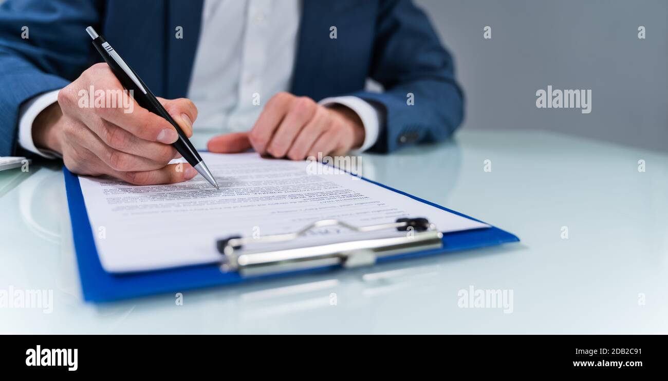 Close-up Of A Person's Hand Signing Contract Stock Photo - Alamy