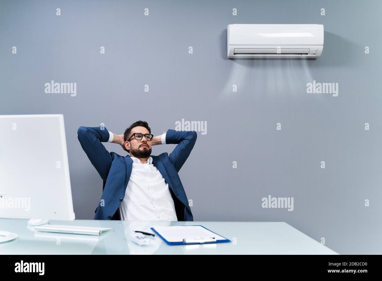 Relaxed Businessman Enjoying The Cooling Of Air Conditioner In The ...
