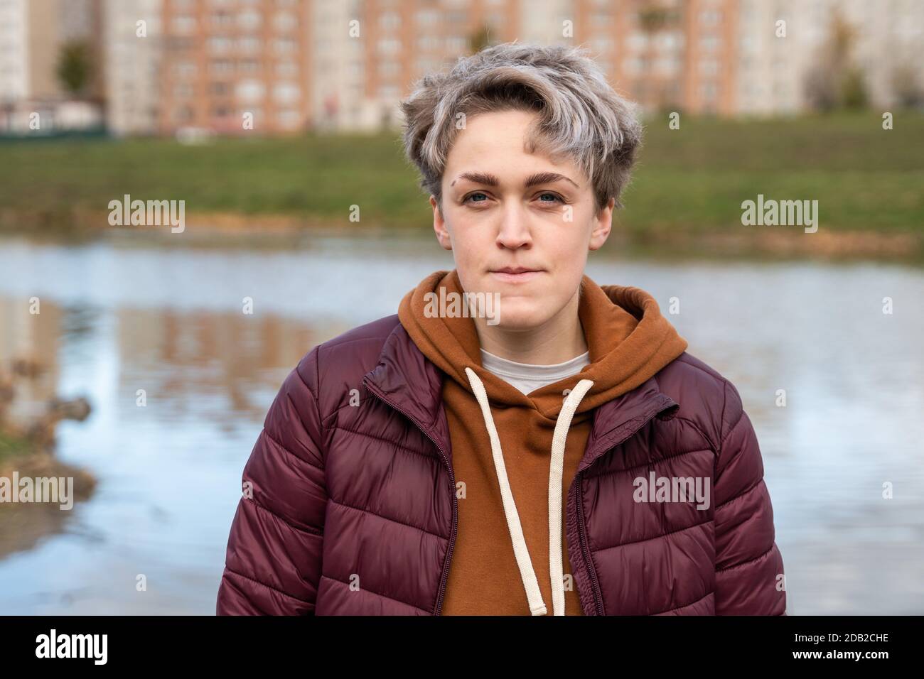 New femininity - gender neutral style. Young woman with stylish short ...