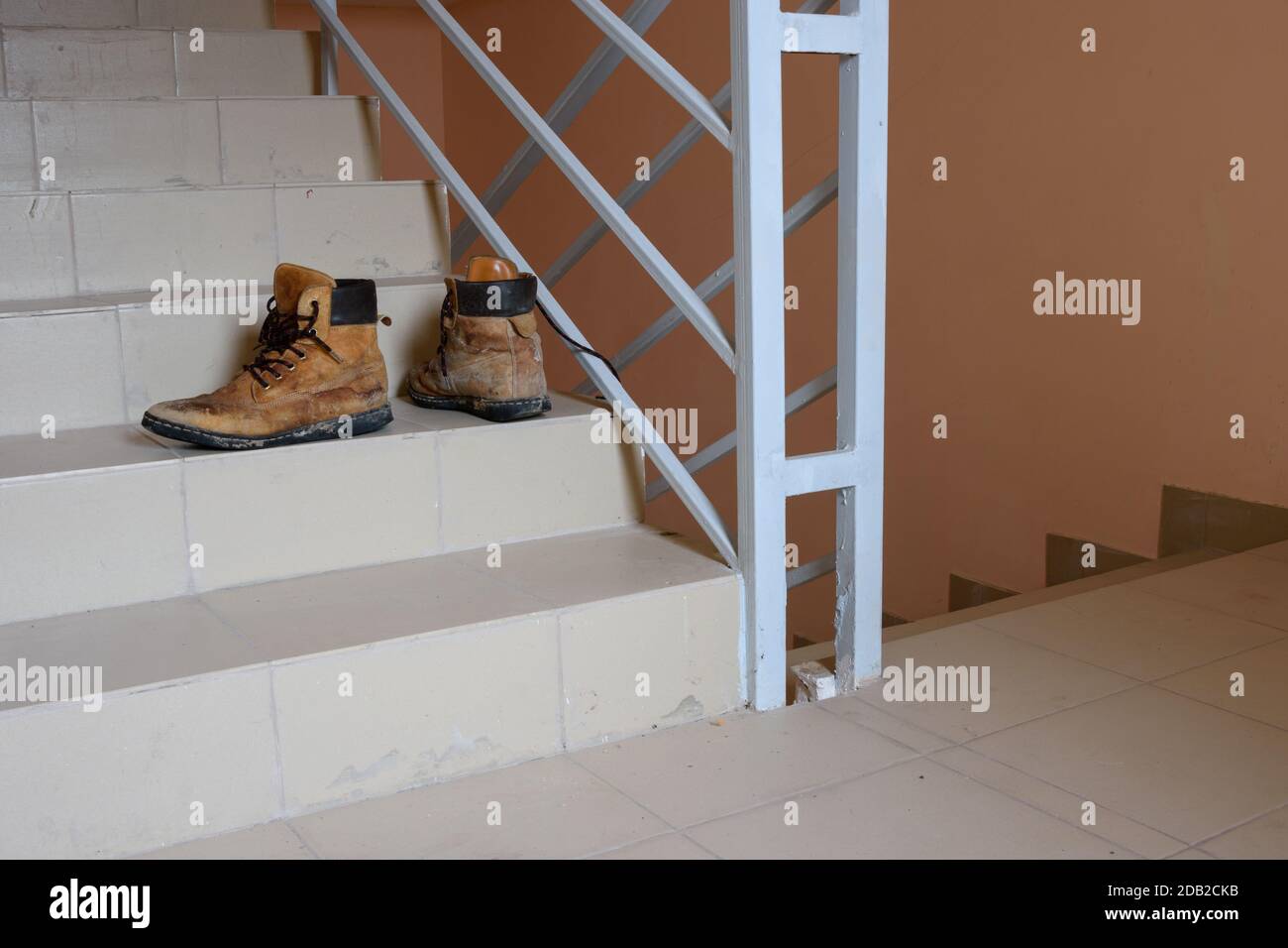 On the steps of the stairs are old shoes Stock Photo - Alamy