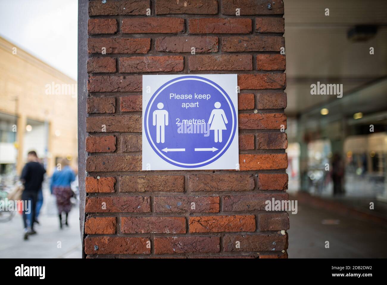 Sign on brick wall requesting people to keep a safe distance Stock ...