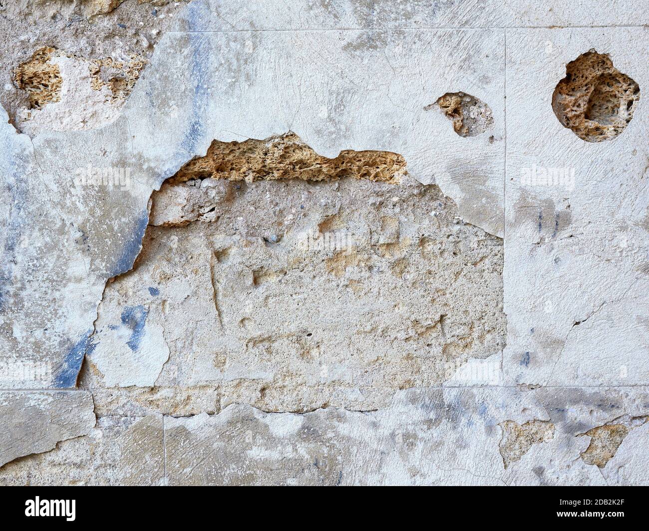 wall of yellow rectangular stones with cement, fragment of ancient ...