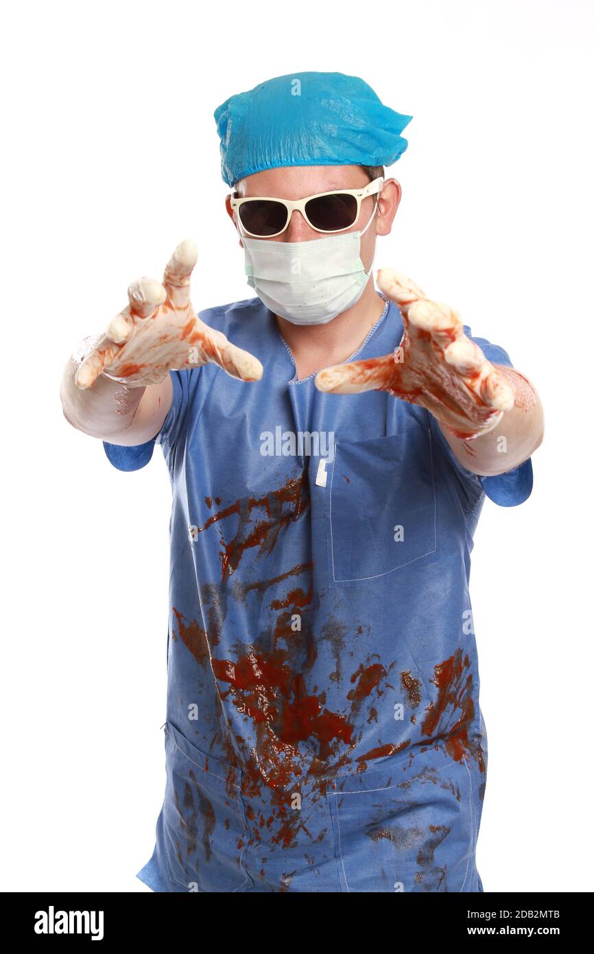 A vertical shot of a doctor with bloody scrubs and sunglasses Stock ...