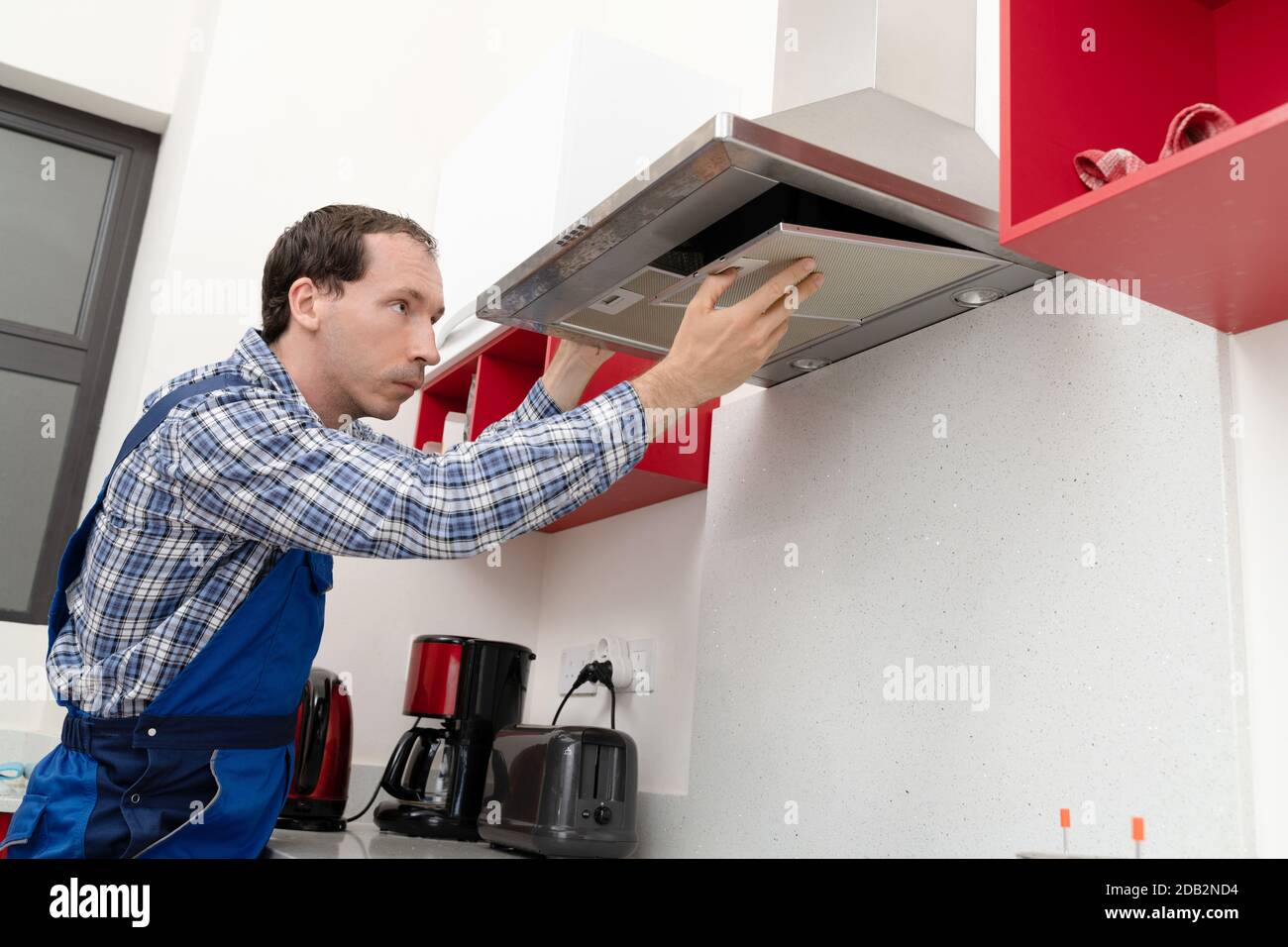 Repairman repairing kitchen extractor hi-res stock photography and ...