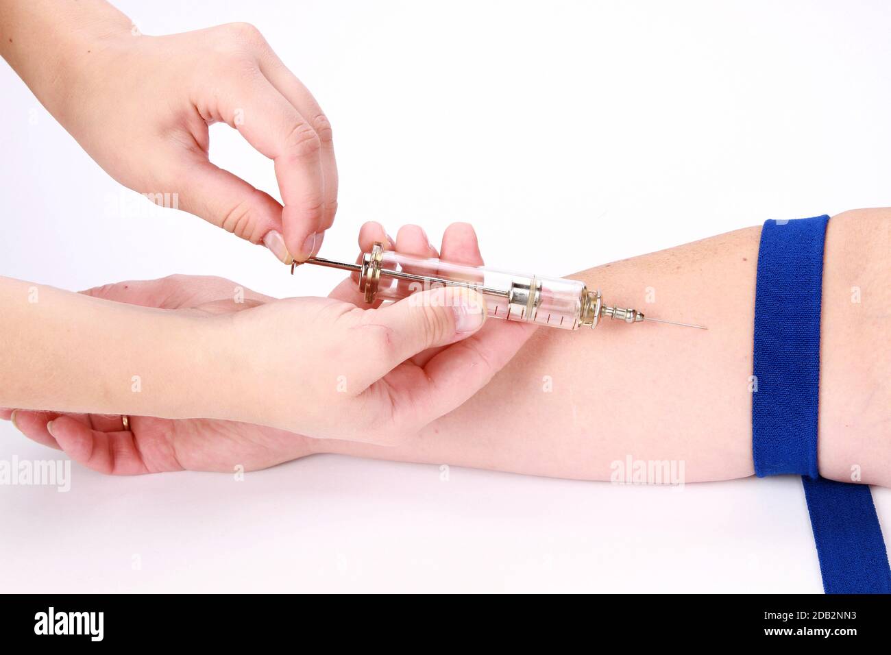 A closeup shot of drawing blood procedure isolated on white background ...