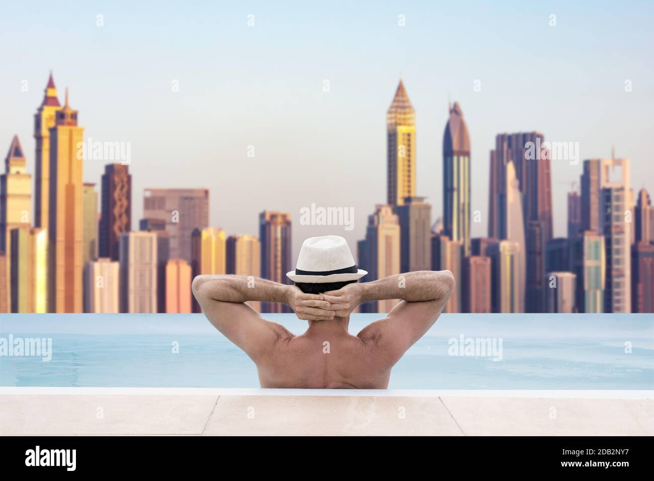 Man In Infinite Swimming Pool With Dubai Skyline In Background Stock ...