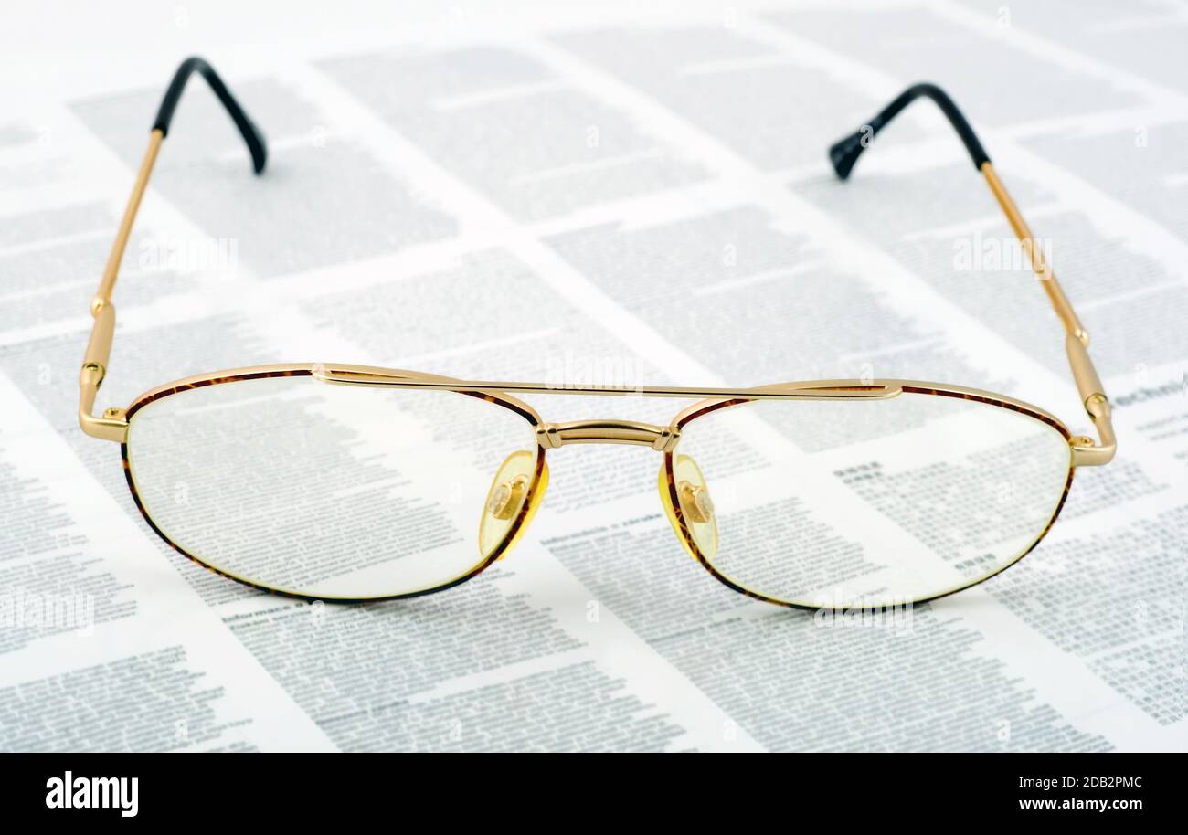 Glasses in document background Stock Photo - Alamy