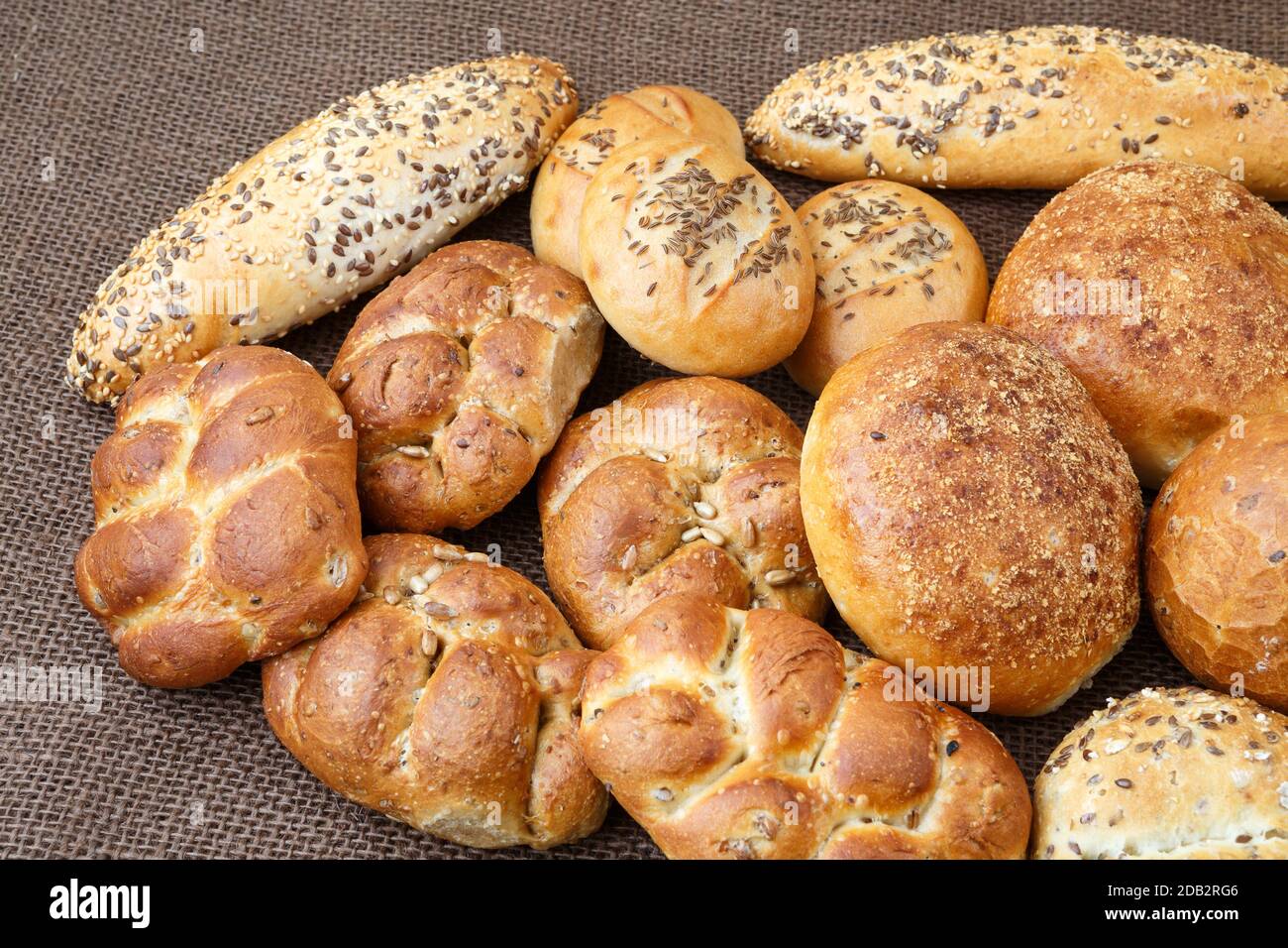 Different sorts of wholemeal breads and rolls on brown background Stock ...