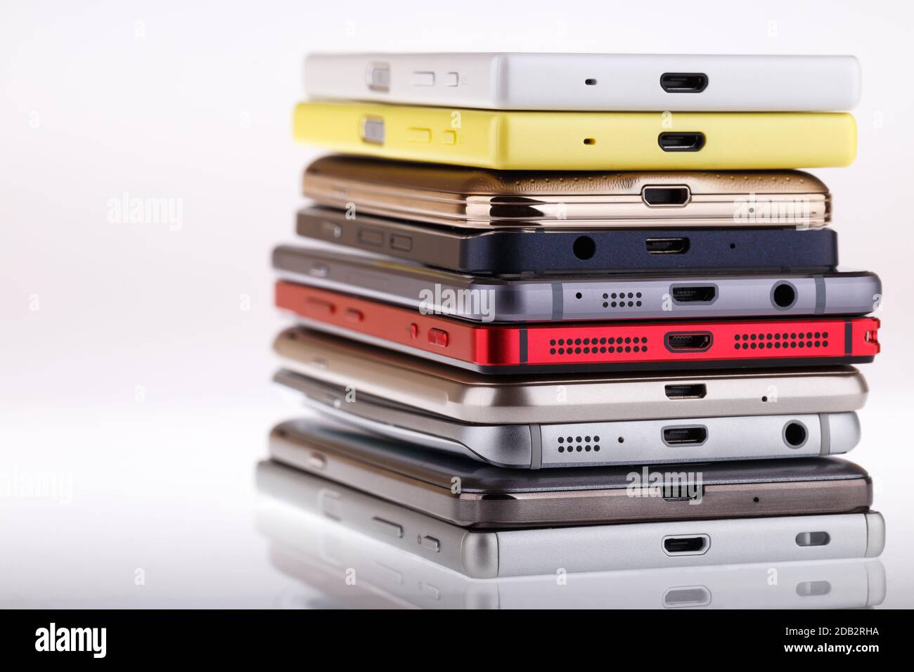 Pile of mobile phone. Heap of the different smartphones isolated on ...