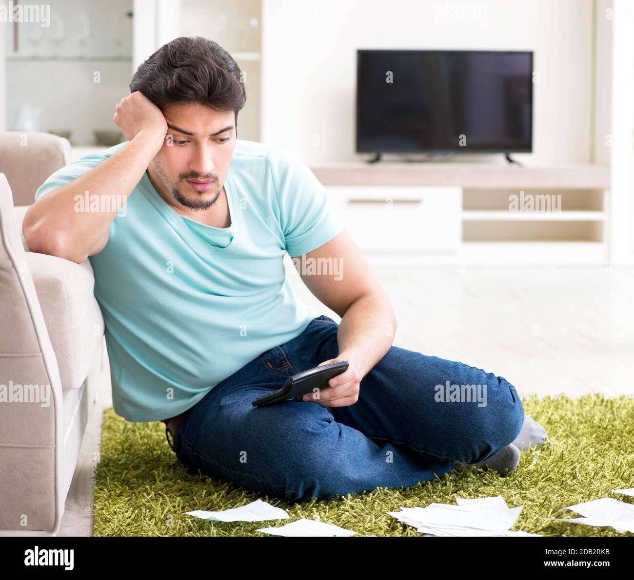 The young man struggling with personal finance and bills Stock Photo ...