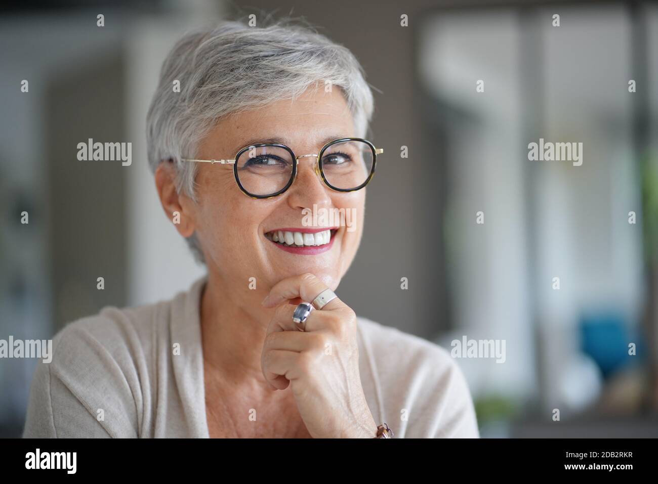 Portrait Of A Attractive Smiling 55 year old Woman With White Hair