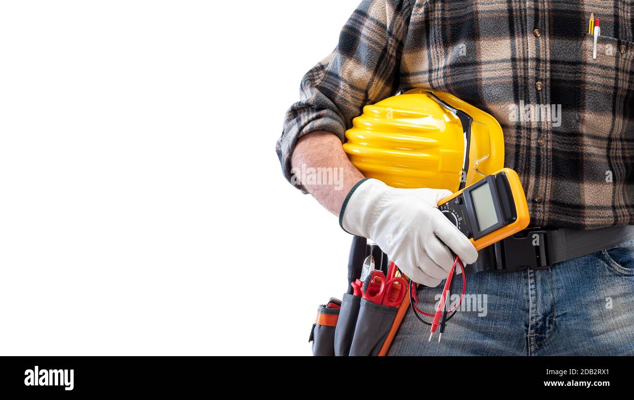 Electrician holds multimeter tester in hand, helmet with protective ...