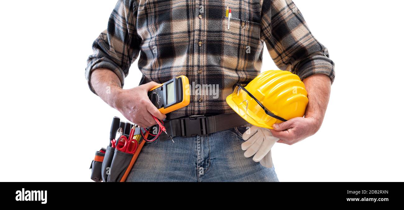 Electrician holds multimeter tester in hand, helmet with protective ...