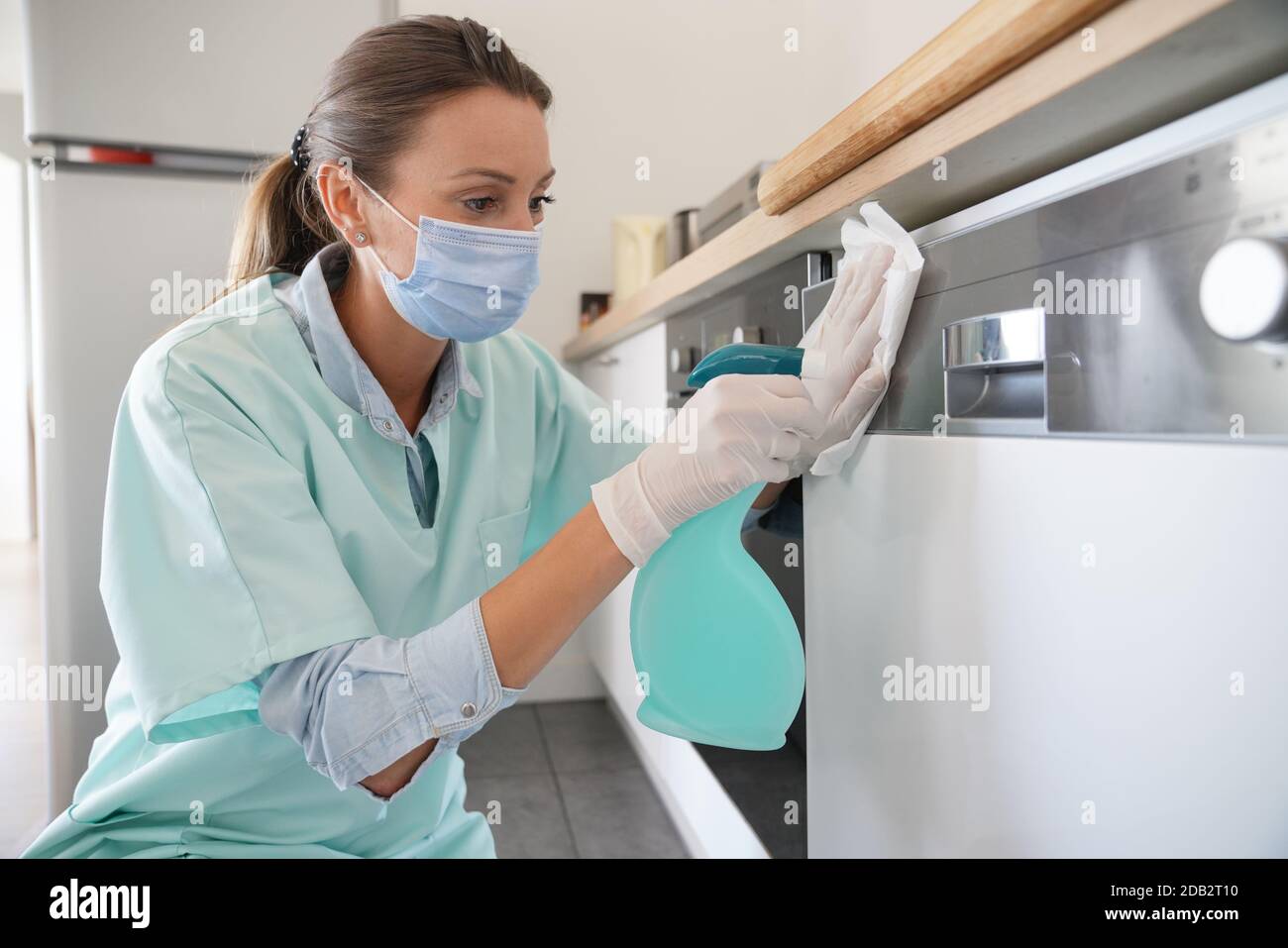 Cleaning woman working with protection mask and gloves Stock Photo - Alamy
