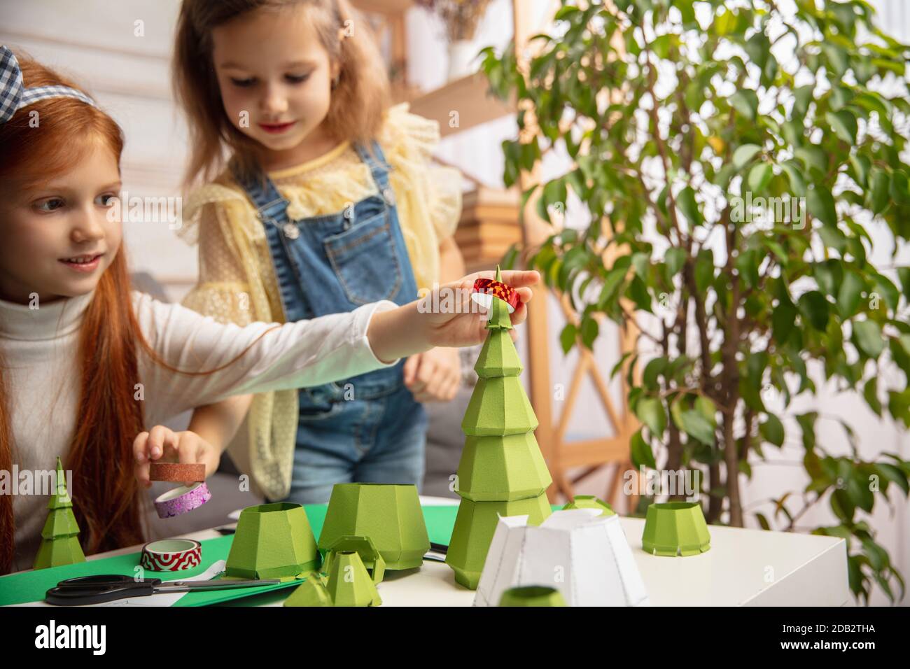 Art. Two little children, girls together in creativity of the house ...