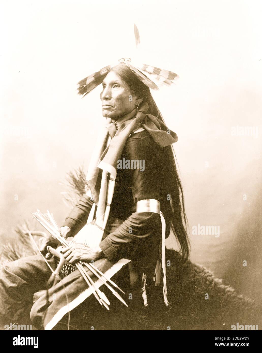 Good Eagle, Indian, three-quarter length, seated, facing left, holding ...