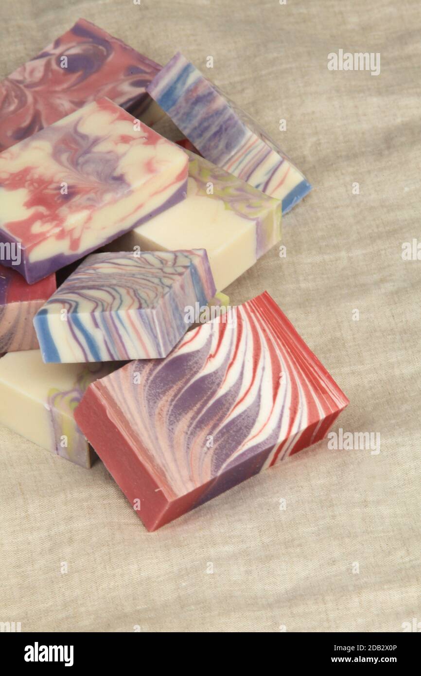Bars of colourful artisanal handcrafted soap on linen backdrop Stock ...