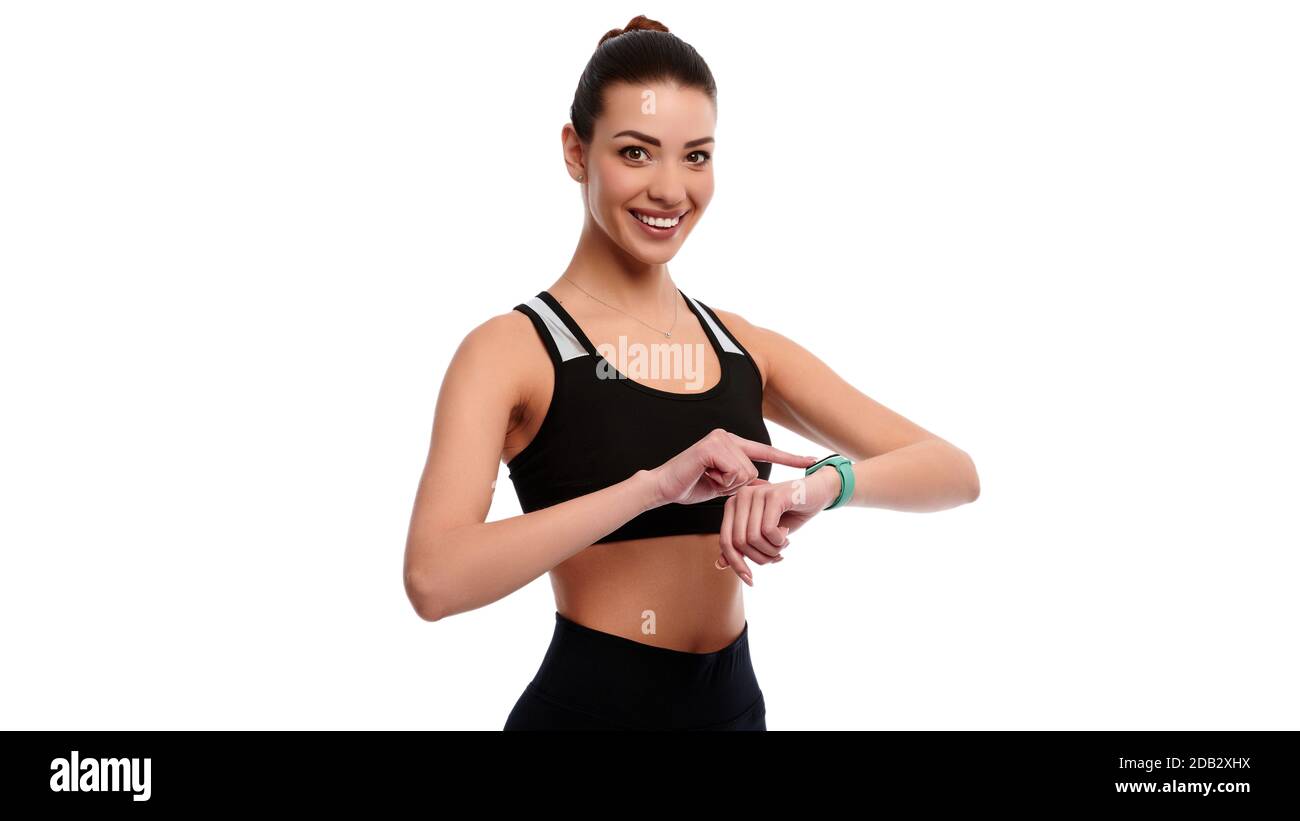 Slim strong caucasian woman in sportswear check smart watches on white ...