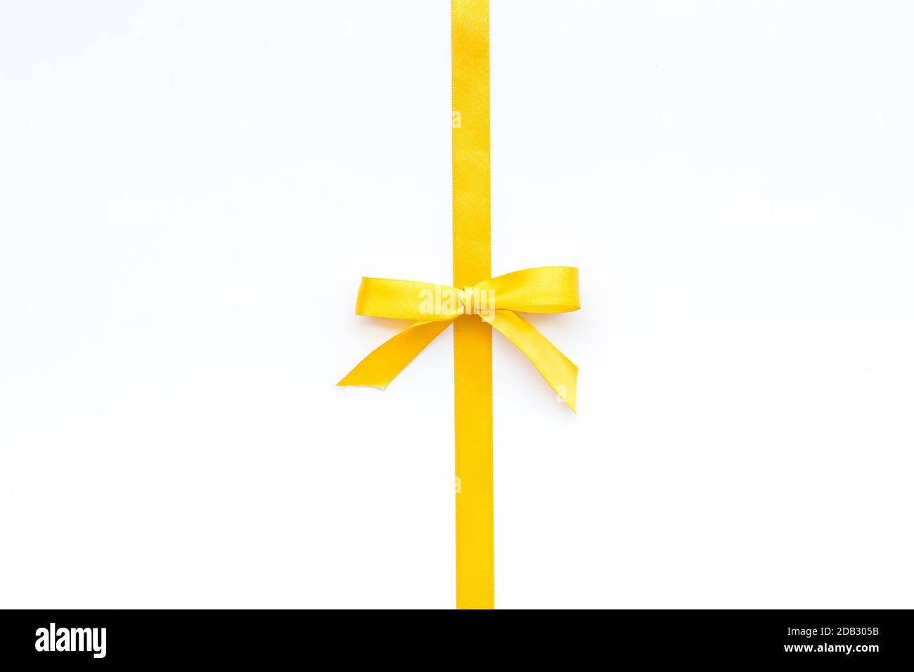 Yellow ribbon bow isolated on white background, top view, copy space ...