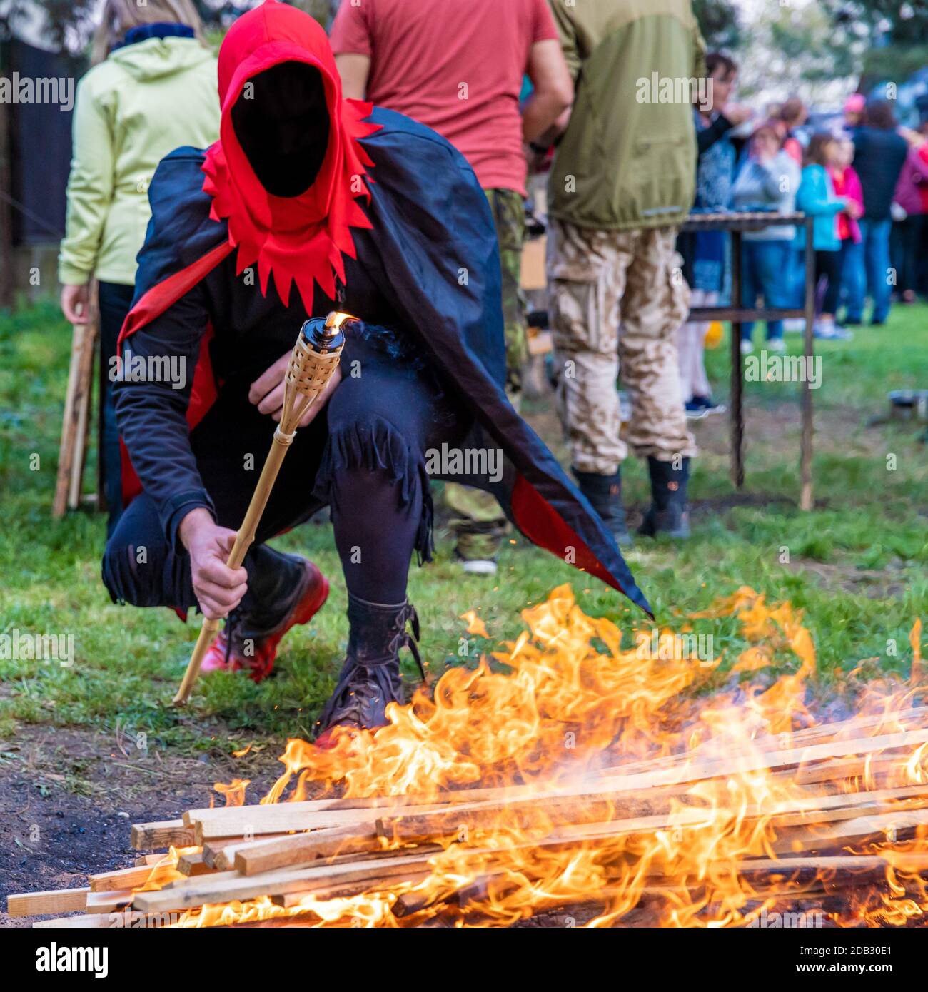 executioner lights a torch by the fire for burning the witch Stock ...