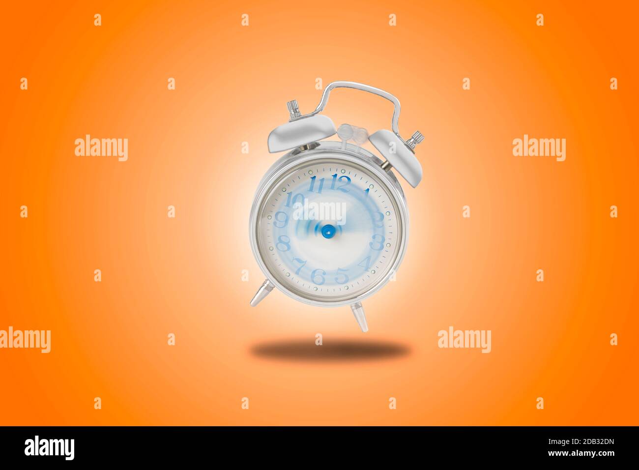 alarm clock, in orange background, that sounds madly with hands that ...