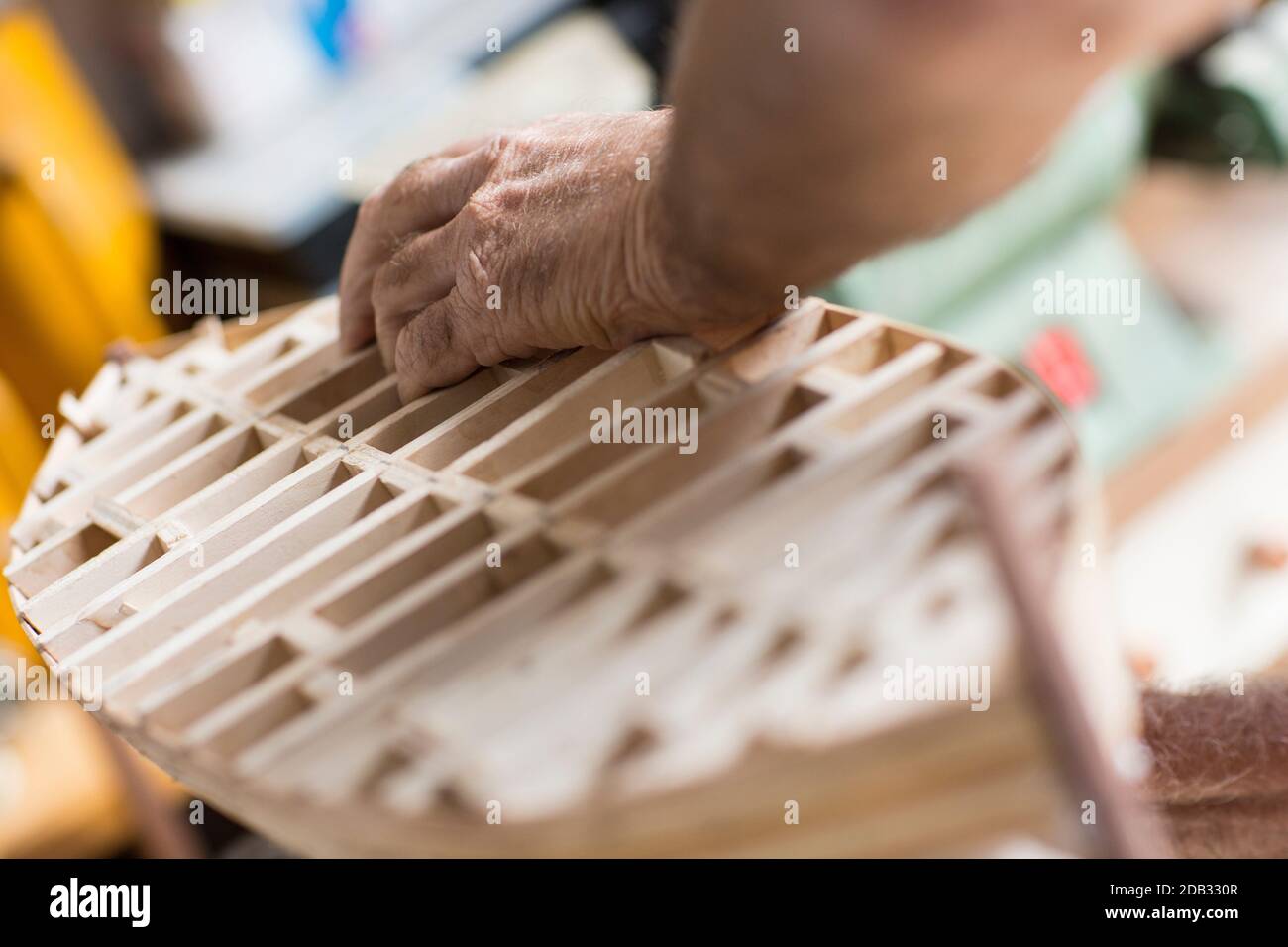 old man working on creating a wooden model of a boat Stock Photo - Alamy