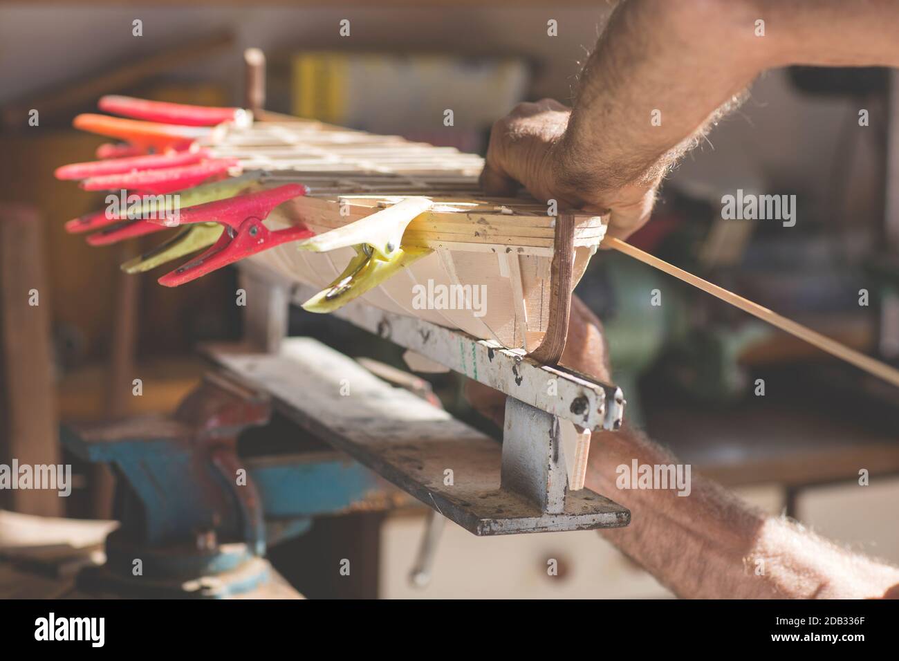 old man working on creating a wooden model of a boat Stock Photo - Alamy