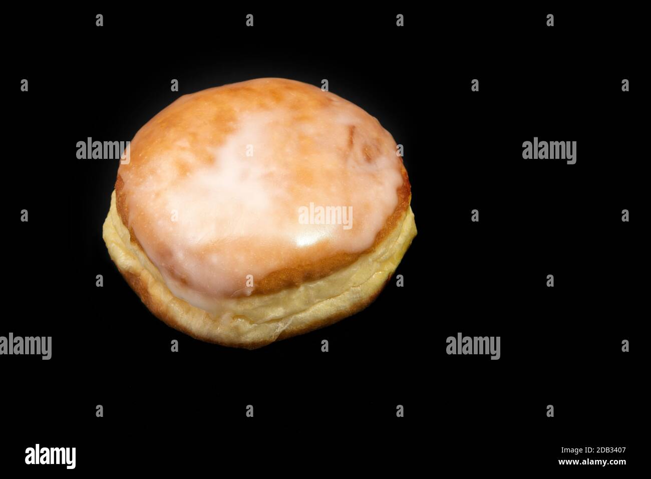 Traditional German Krapfen or dougnut with sugar icing on black ...