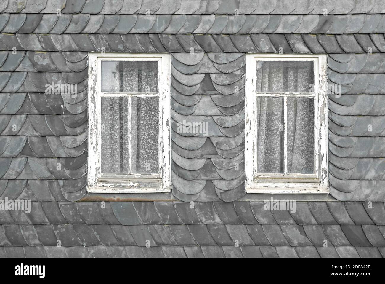 Slate tiles with two old windows on a facade of a typical home in ...