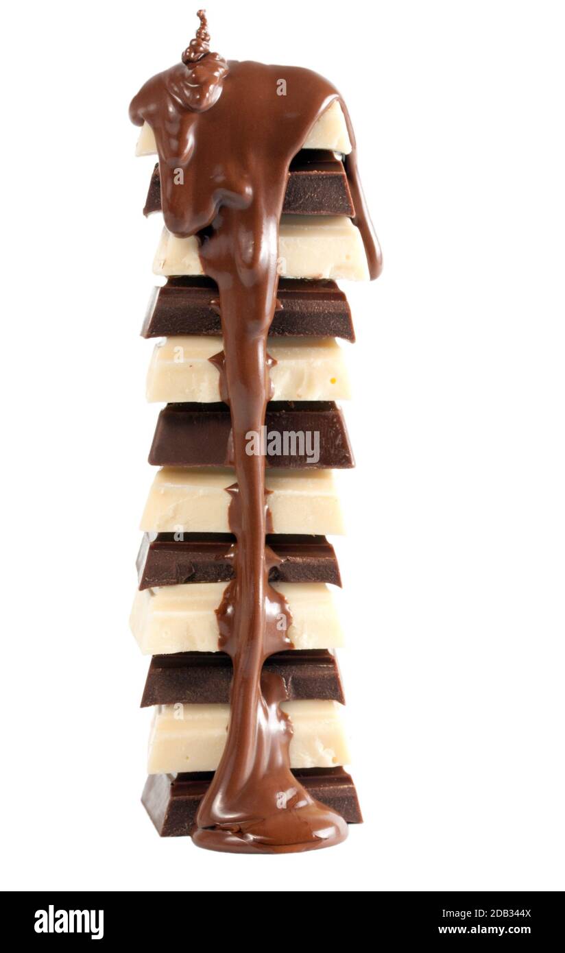 Pouring chocolate on stack of chocolate pieces isolated on a white ...