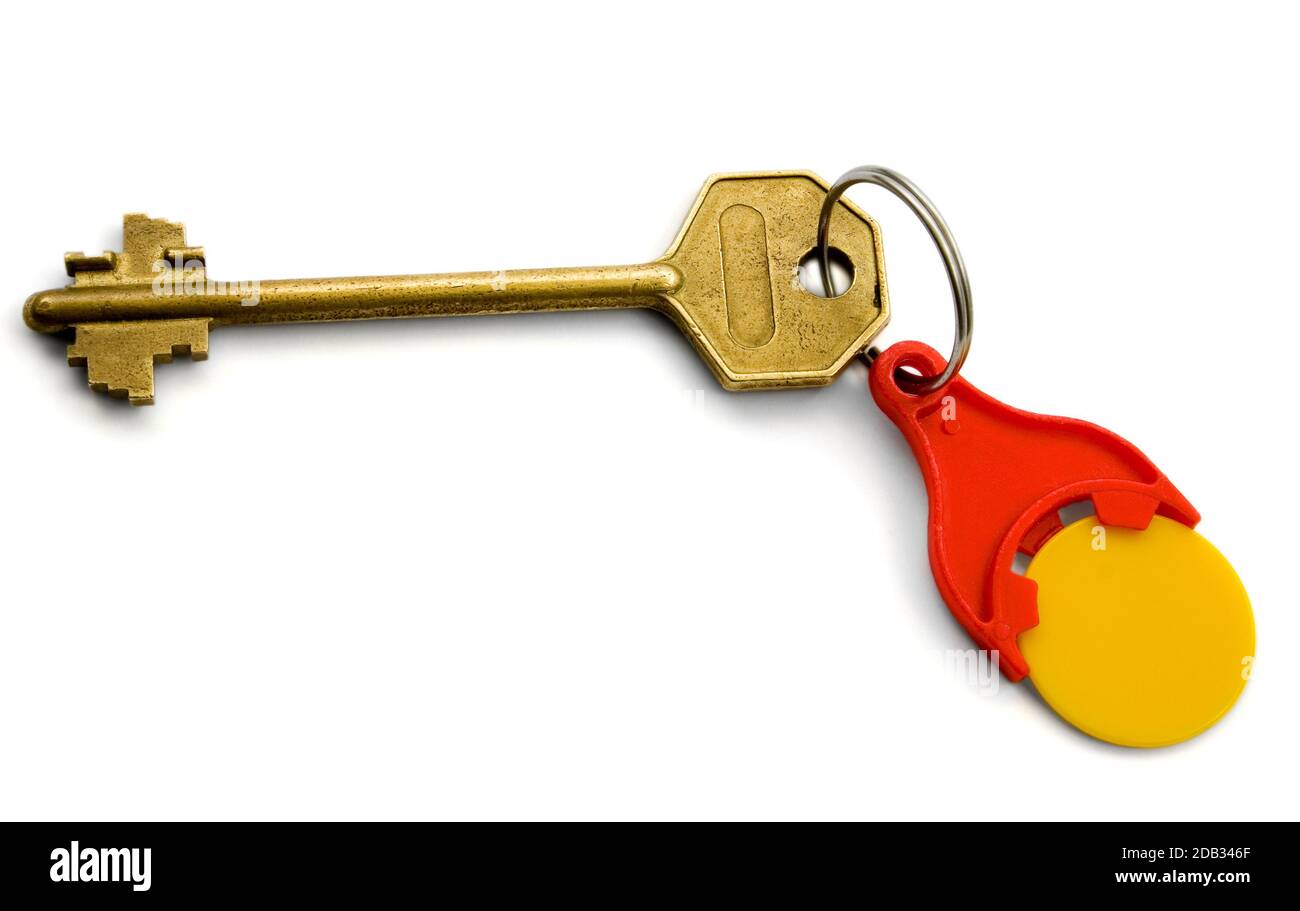 Isolated bronze Key with red key ring for coins On White background ...