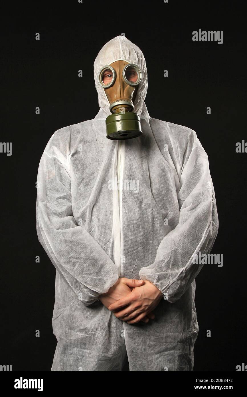 A portrait of a male in full protective clothing wearing a gas mask ...