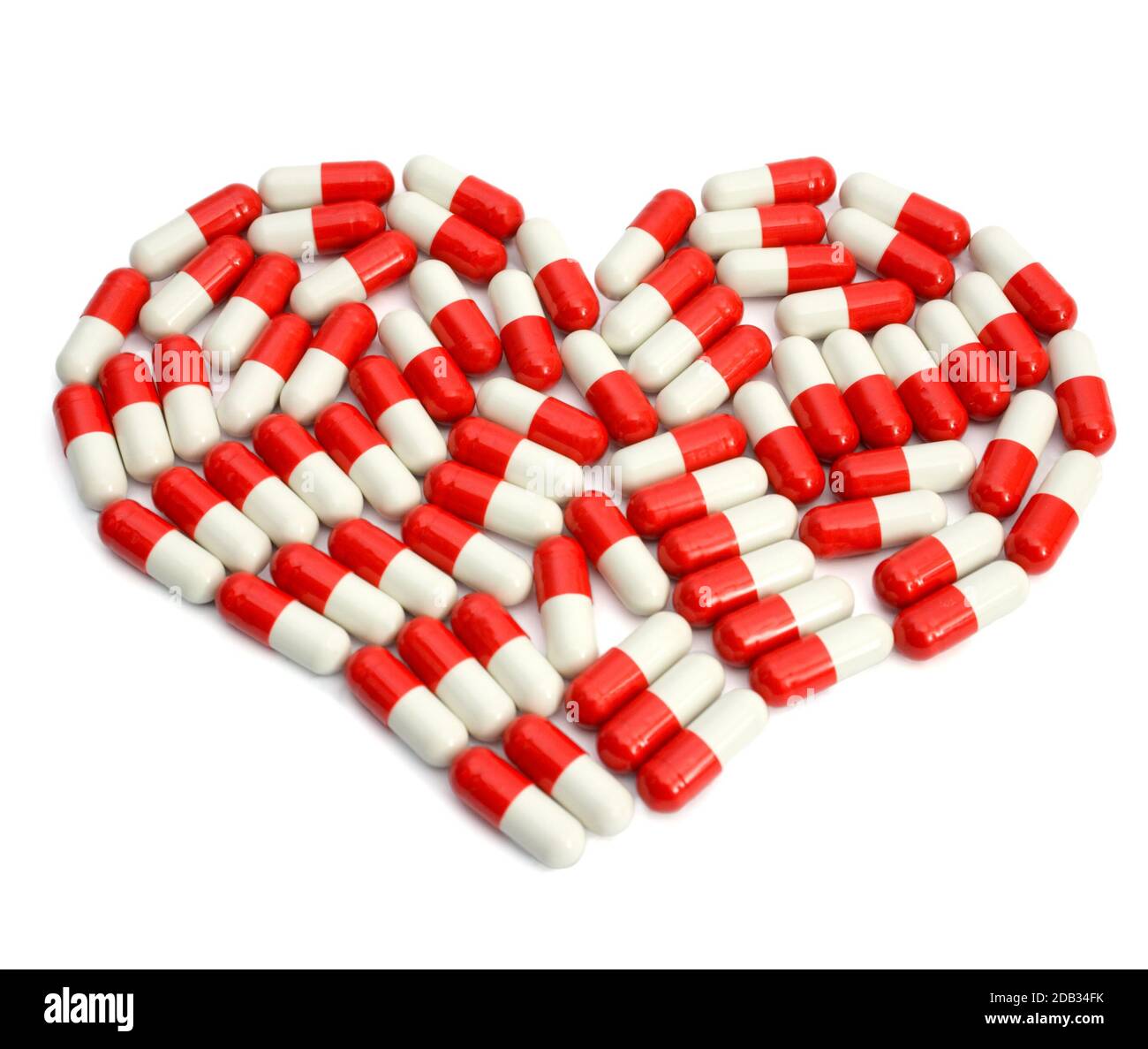 Capsule formed heart, isolated on white background Stock Photo - Alamy