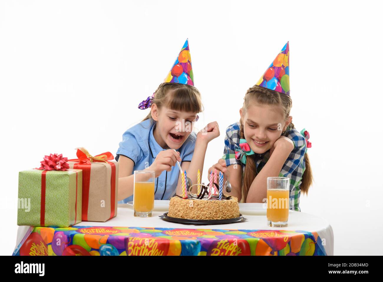 Children eat a birthday cake with a spoon, isolated on a white ...