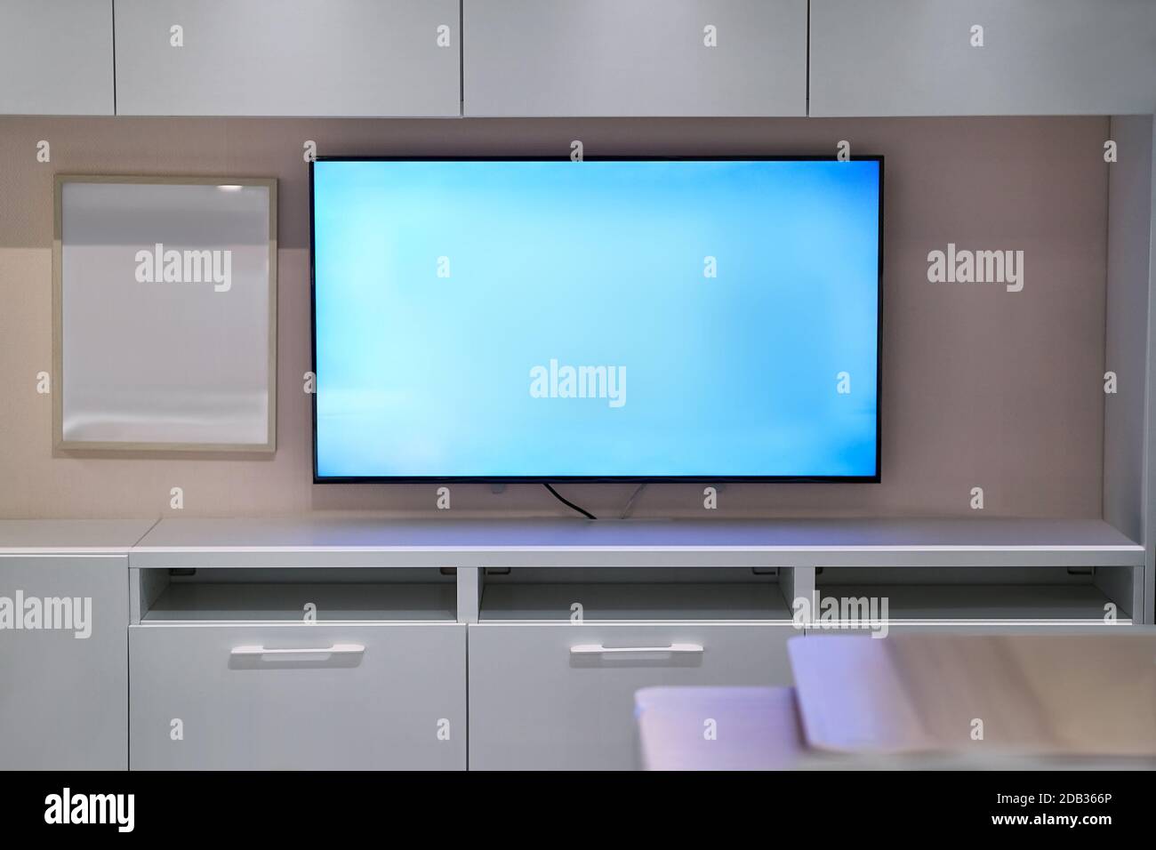 Tv room with bright interior and glowing blue light of LCD screen Stock ...