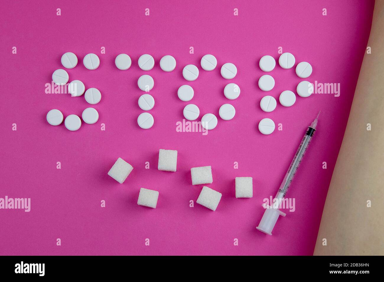 The word stop is made of tablets, next to the outline of the hand ...