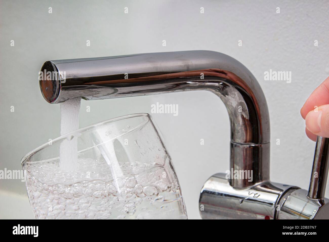 Glass at water tap and filling water with lead contamination Stock ...