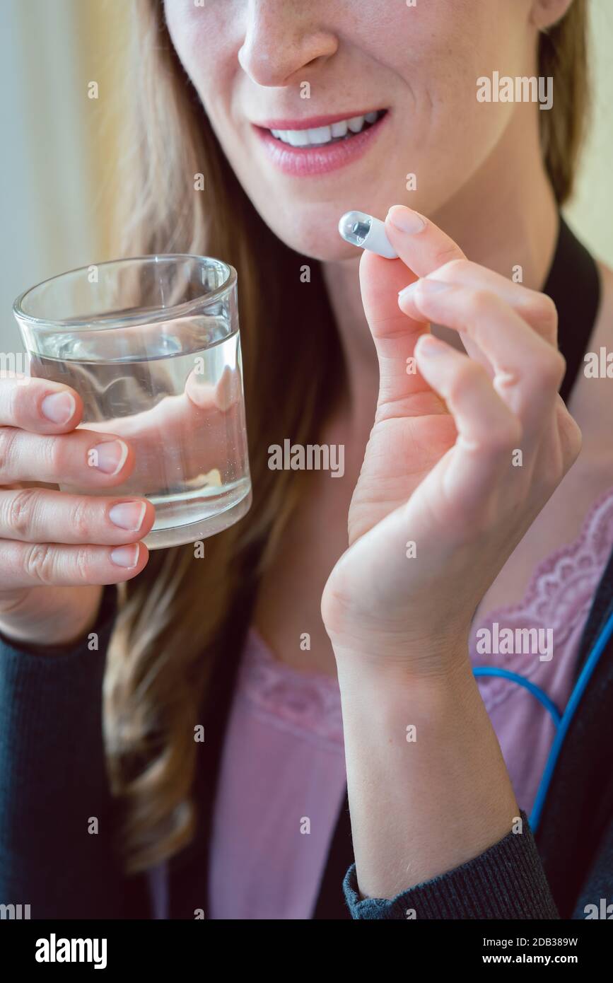 Woman patient swallowing capsule endoscopy video pill with water Stock ...
