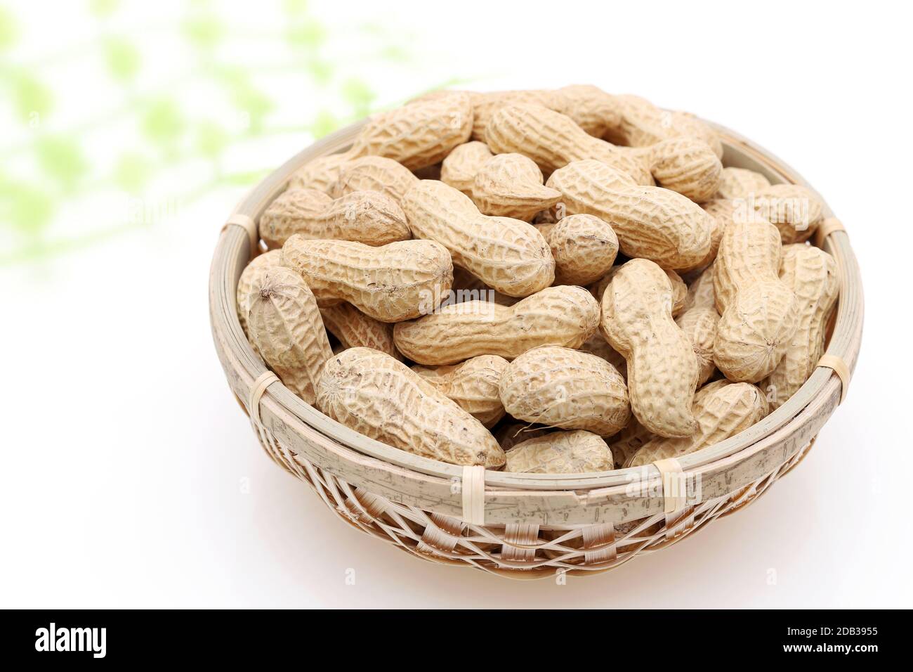 Organic peanuts in shell in a bamboo basket on white background Stock ...