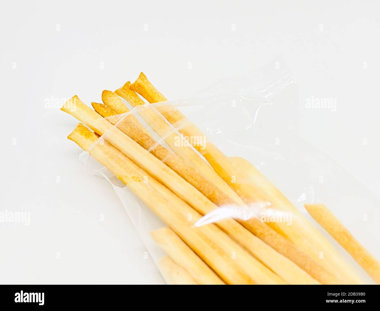 A group of Italian breadsticks isolated on a white background wrapped ...