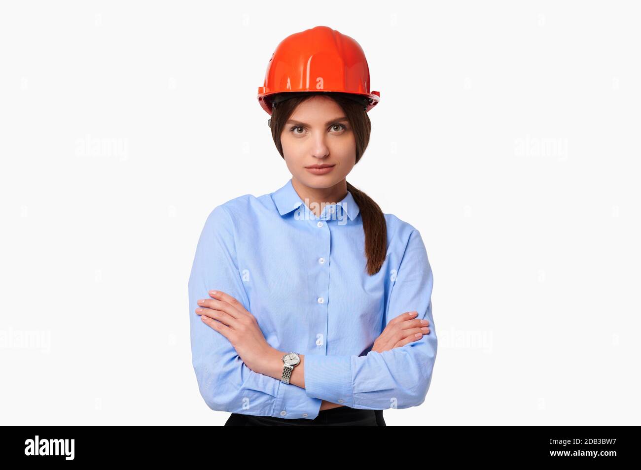 Crossed arms caucasian female engineer in helmet on white isolated ...