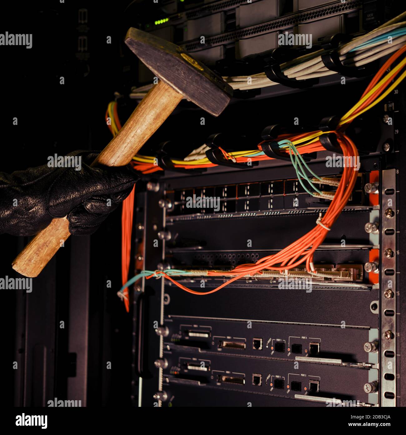 Hammer in man hand near server equipment with wires. Concept of ...