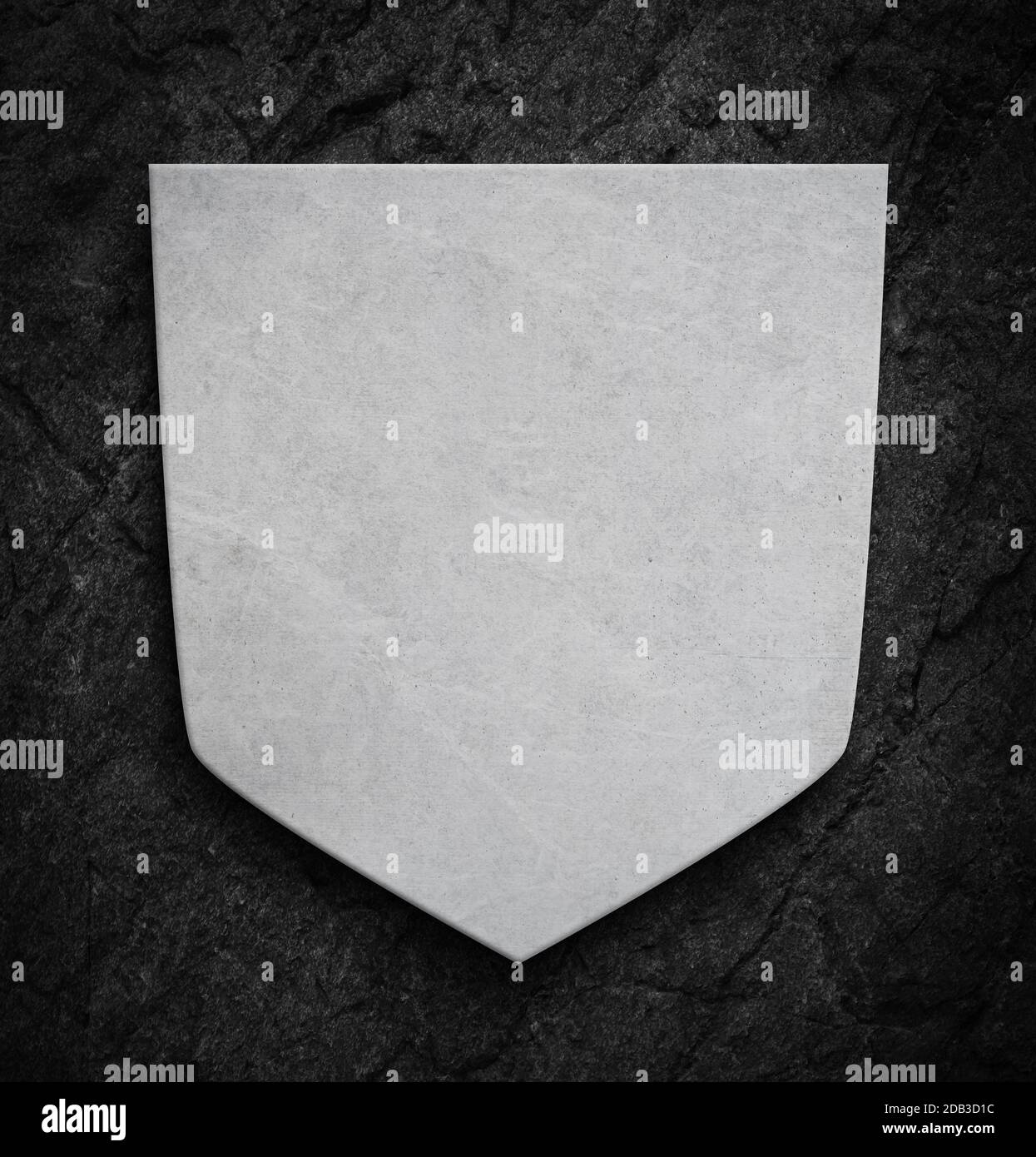 White sign of stone with shield shape in front of a solid dark rock ...