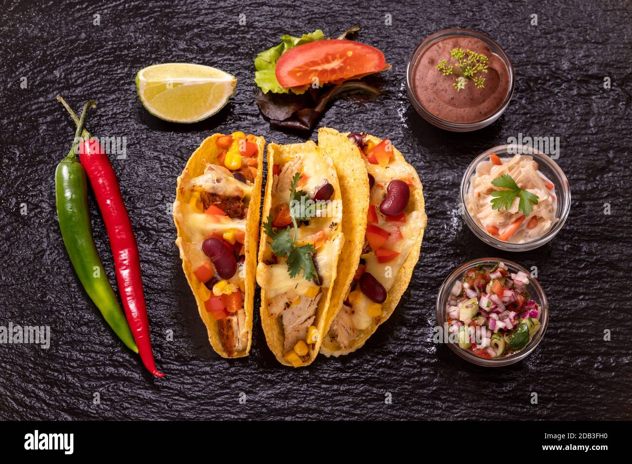 three mexican tacos on slate Stock Photo - Alamy