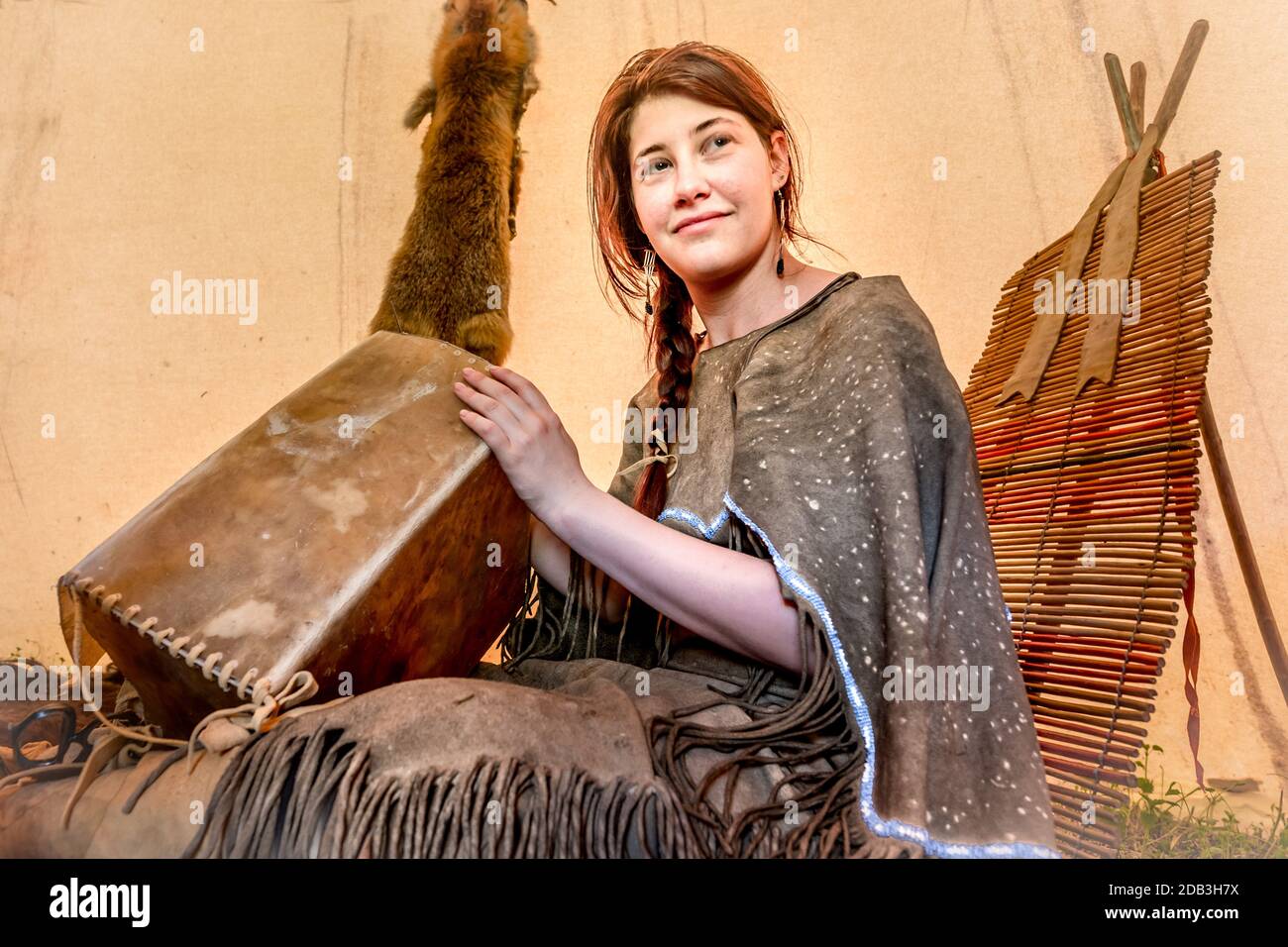 Young Lakota girl sits smiling in a tipi and makes a rawhide box Stock ...