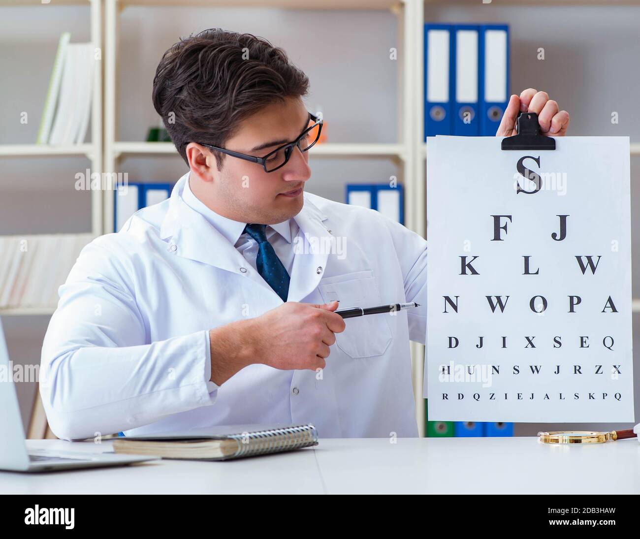 The doctor optician with letter chart conducting an eye test check ...