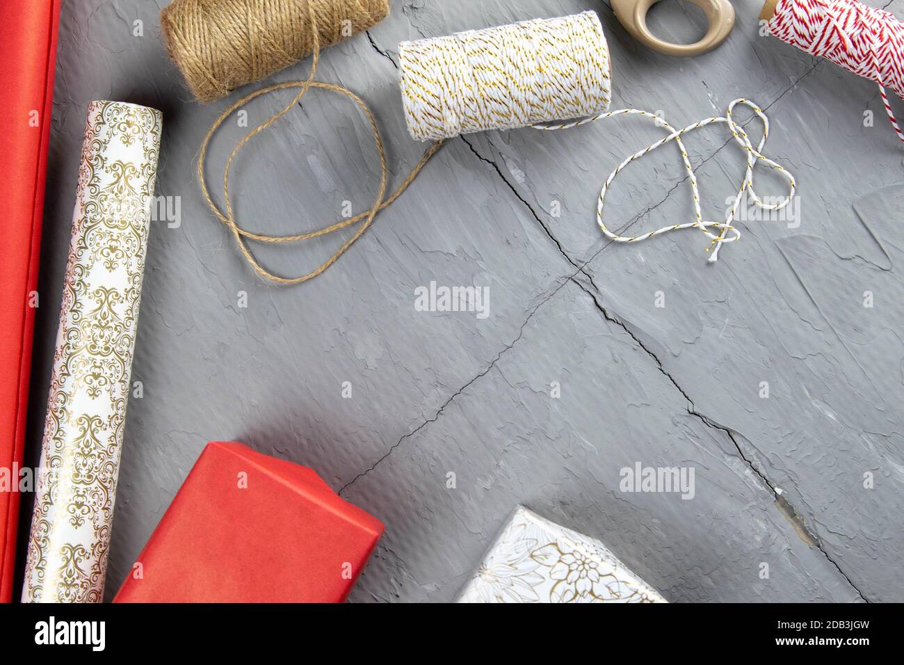 Preparing for the packaging of gifts, on the table laid out red and ...