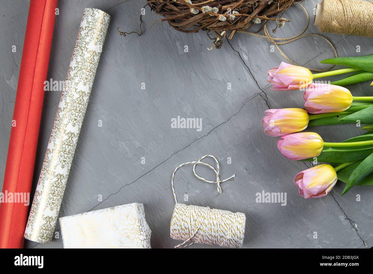 Preparing for the packaging of gifts, on the table laid out red and ...